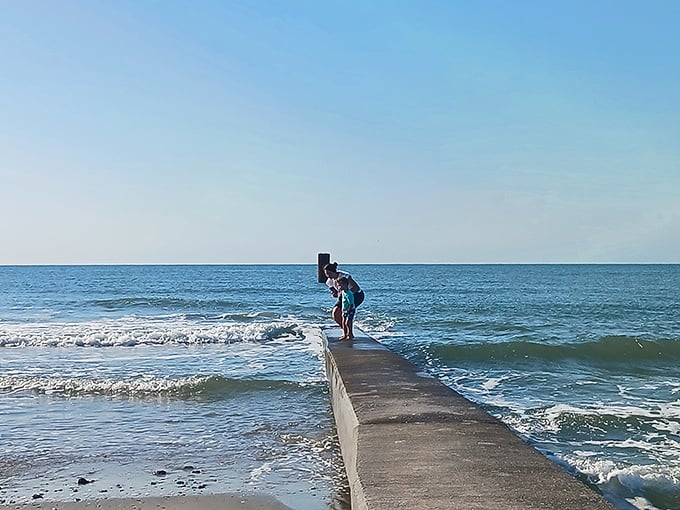 Walking the line between land and sea. The jetty extends like a concrete runway into the Atlantic, a perfect perch for contemplation or fishing.