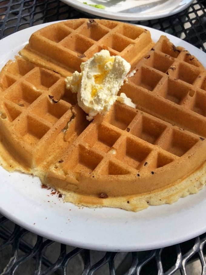 Behold the star attraction – a golden waffle with deep pockets perfectly designed for capturing rivers of melting butter and maple syrup.