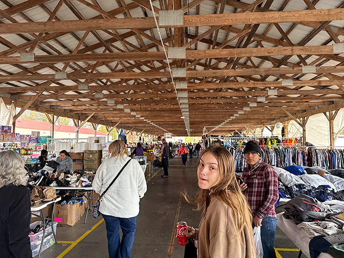 Under rustic wooden beams, shoppers navigate the covered walkways like explorers in a jungle of potential treasures and unexpected finds.