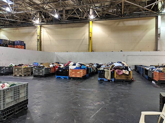 Organized chaos at its finest. These bins aren't just containers—they're time capsules filled with yesterday's treasures waiting for tomorrow's homes.