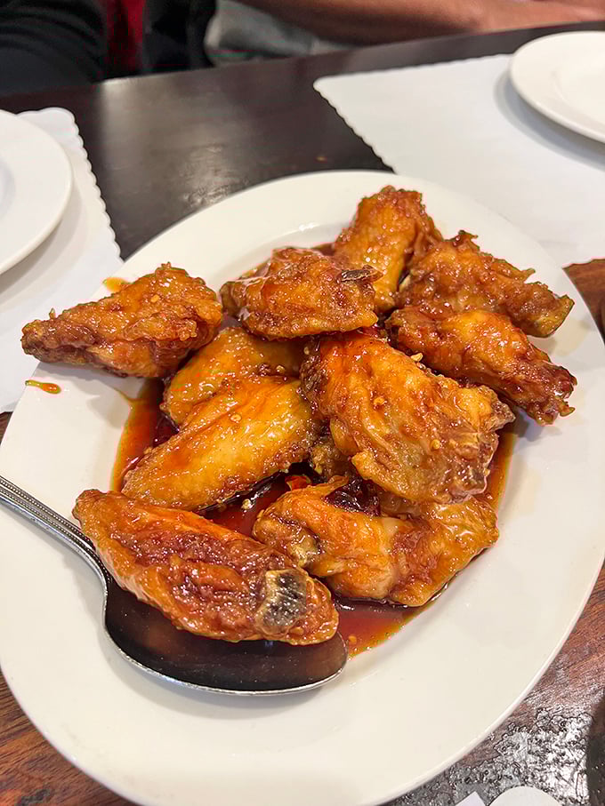 The star of the show: dry-fried chicken wings glistening with that addictive sauce. Crispy, sticky, sweet, and savory – resistance is futile.