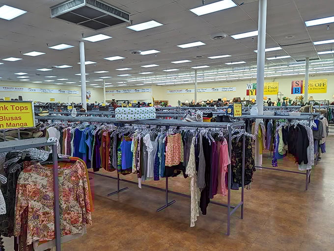 Women's blouses hang in chromatic harmony, a rainbow of possibilities. That perfect silk top from the '80s is hiding here somewhere. 