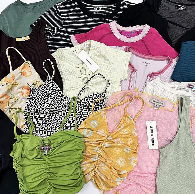 A rainbow of possibilities hanging neatly in rows. Each top tells a story—hopefully not one involving mysterious stains or questionable fashion choices.