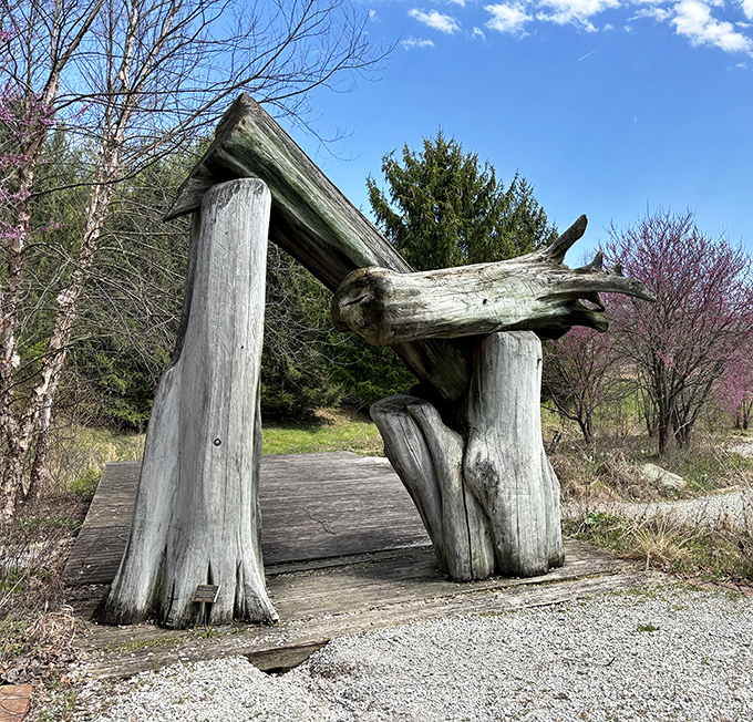 The wooden archway beckons like a portal to another dimension—or at least to the next magnificent sculpture around the bend.