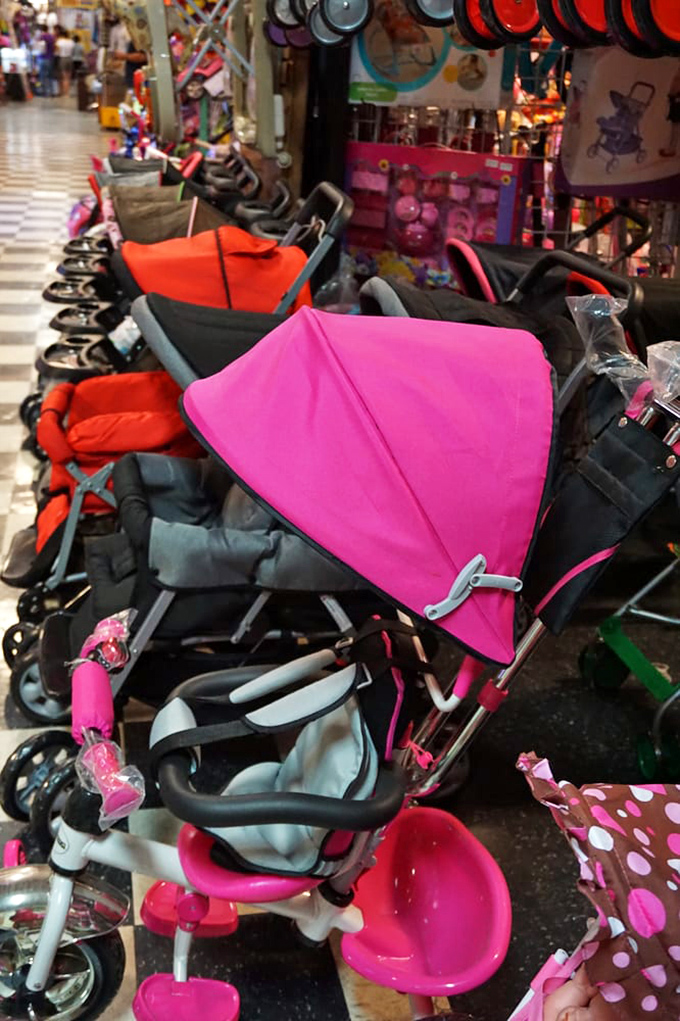 Stroller boulevard stretches as far as the eye can see. Pink, blue, and every shade between—because even the tiniest shoppers deserve transportation with personality.
