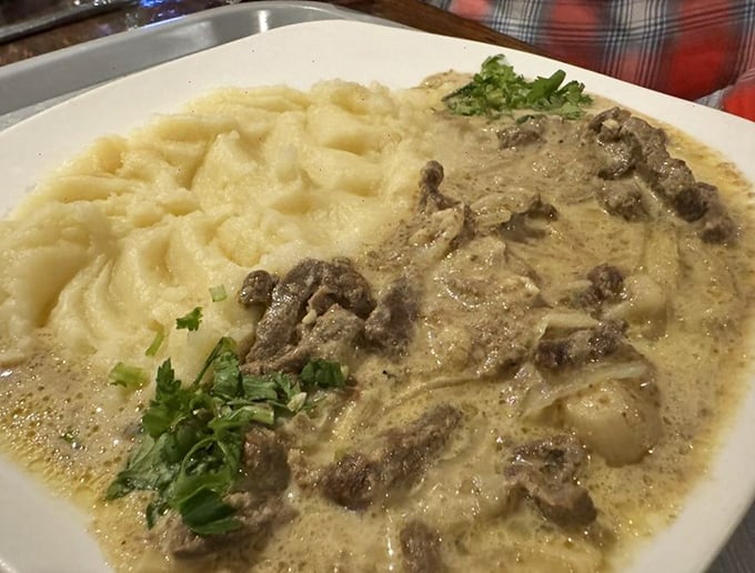 Behold the legendary beef stroganoff—tender meat swimming in a sauce so perfectly balanced it could negotiate world peace.