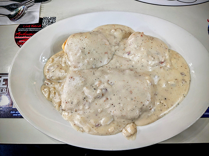 Biscuits and gravy that doesn't just smother—it embraces. This plate isn't a meal, it's a warm hug from your grandmother's kitchen.