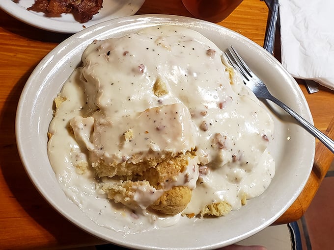 Biscuits and gravy nirvana! This plate doesn't just satisfy hunger – it creates memories with every pepper-flecked, sausage-studded, velvety bite.