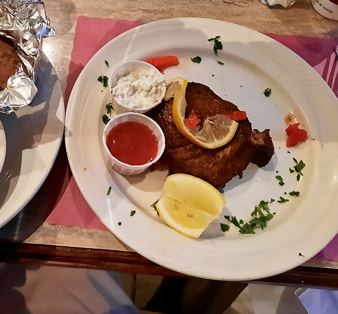 This blackened fish isn't just dinner – it's theater on a plate, complete with lemon wedges playing supporting roles to the perfectly seasoned star.