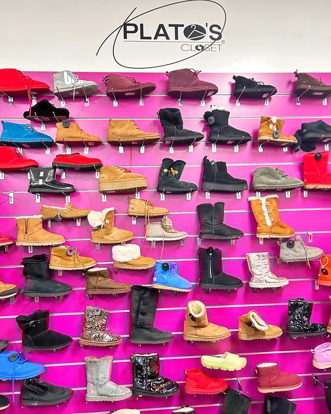 A vibrant display of boots on hot pink shelving—like a dessert case for your feet, but without the calories.