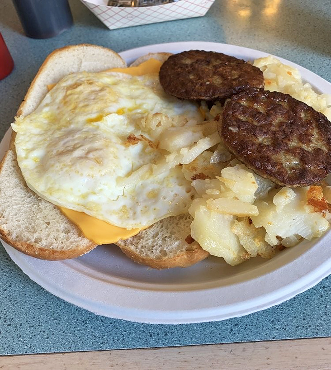 Breakfast engineering at its finest – perfectly cooked eggs, golden hash browns with that ideal crispy-to-fluffy ratio, and sausage patties that mean business.