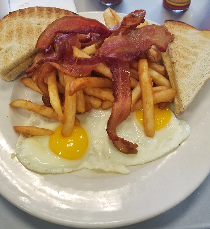 Behold the breakfast trinity: perfectly sunny-side-up eggs, crispy golden fries, and bacon that's achieved that magical state between chewy and crisp.