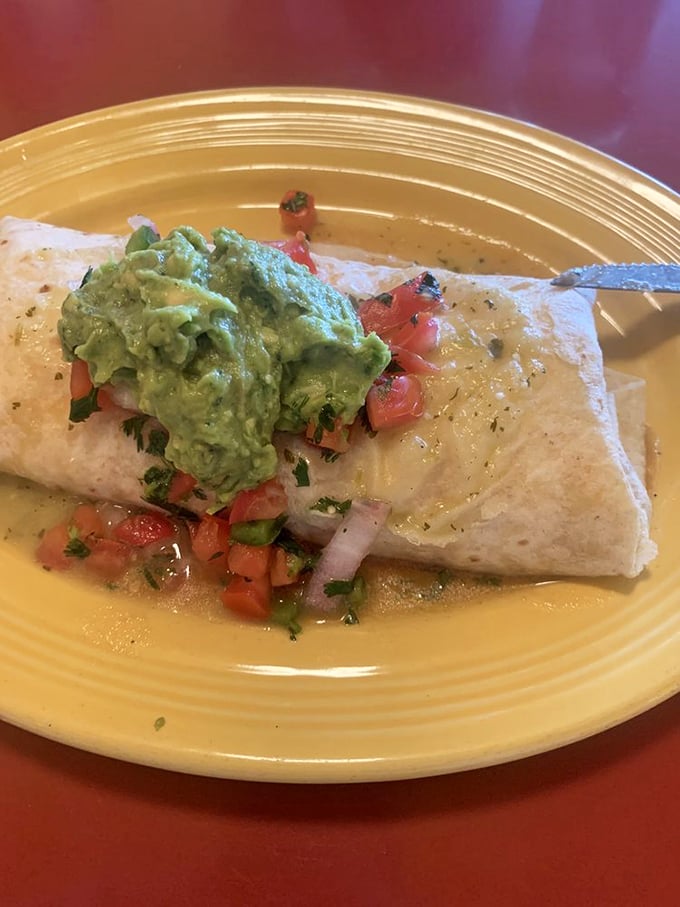 Breakfast burrito nirvana – a perfect package of morning bliss topped with fresh avocado that makes kale smoothies weep with inadequacy.