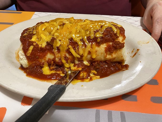 This burrito isn't just wrapped—it's embraced by a tortilla and smothered with enough cheese and sauce to make your cardiologist wince. Worth it.