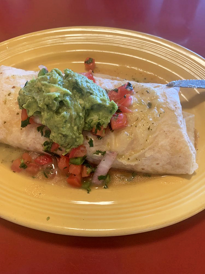 Breakfast burrito nirvana – a perfect package of morning bliss topped with fresh avocado that makes kale smoothies weep with inadequacy.