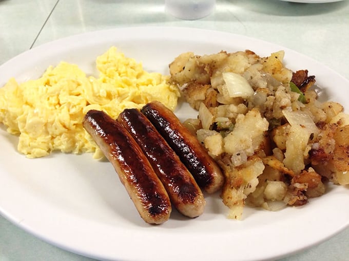 Breakfast perfection on a plate: scrambled eggs that look like clouds, sausage links with that perfect snap, and home fries that could make a potato proud.
