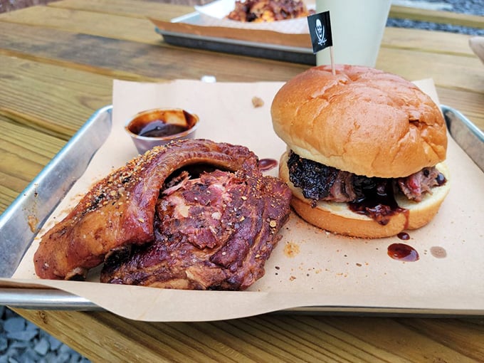 Meat nirvana exists, and it looks exactly like this—a perfectly smoked brisket sandwich with a side of ribs that would make angels weep.