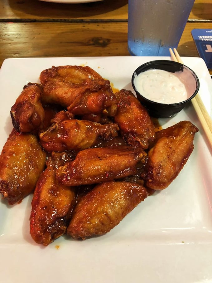 These buffalo wings aren't messing around – crispy, saucy, and demanding to be devoured with the kind of enthusiasm usually reserved for finding a parking spot at the beach.