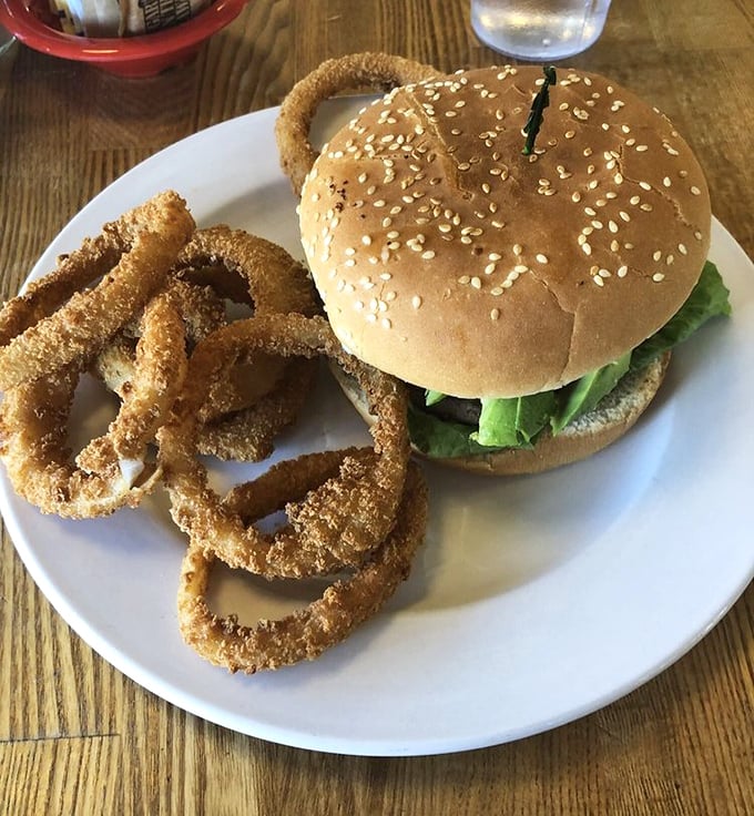 That perfect burger moment – when the sesame seed bun meets a juicy patty and those golden onion rings stand at attention.