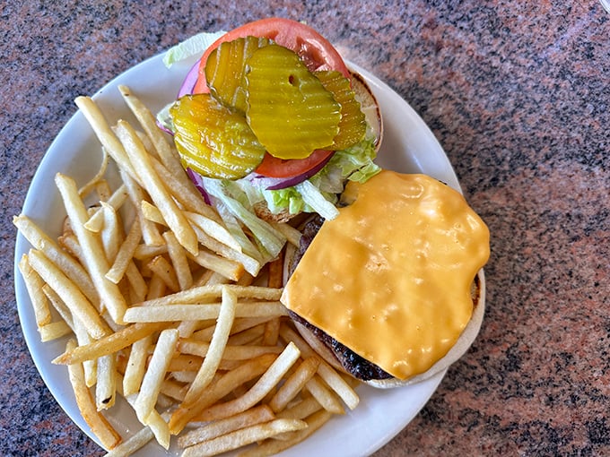 This isn't just a cheeseburger and fries—it's therapy on a plate, with those crinkle-cut pickles adding the perfect tangy counterpoint.