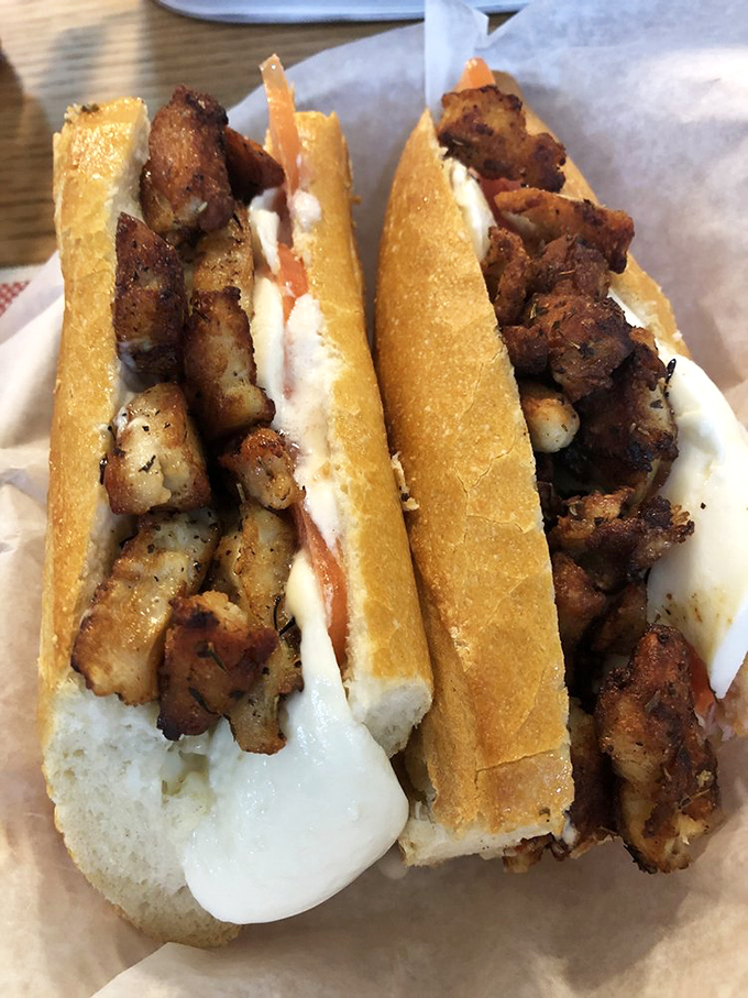 This chicken sandwich isn't just lunch—it's architecture. Perfectly seasoned meat nestled in a crusty baguette that shatters with each blissful bite.