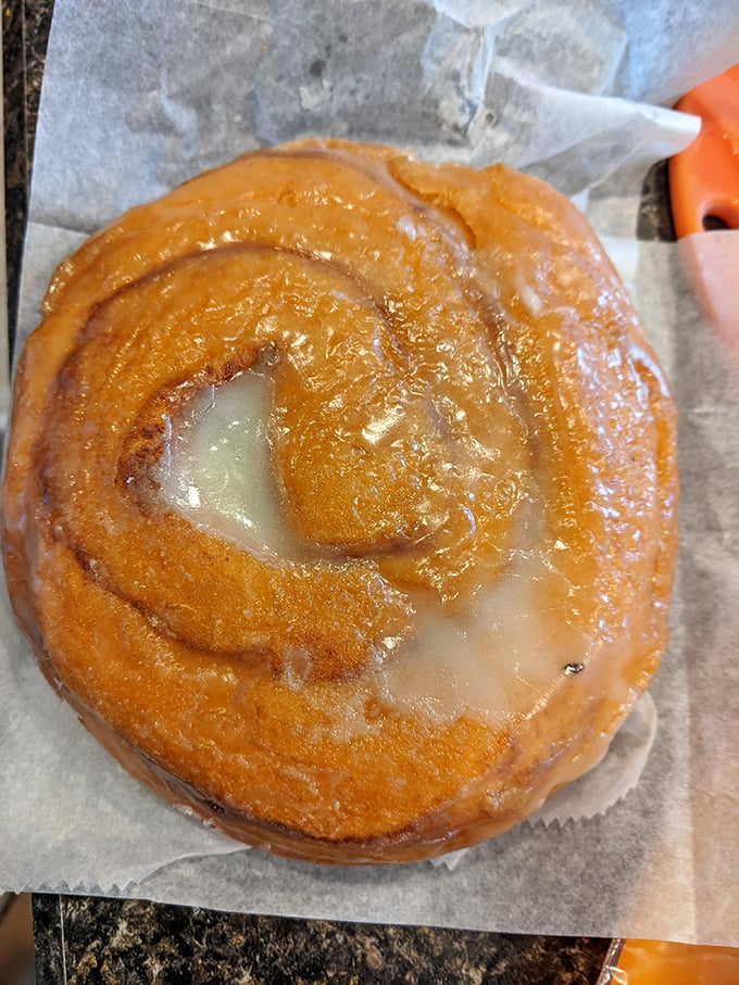 This cinnamon roll isn't just breakfast—it's an edible hug with a sweet glaze smile that says "good morning" better than coffee ever could.