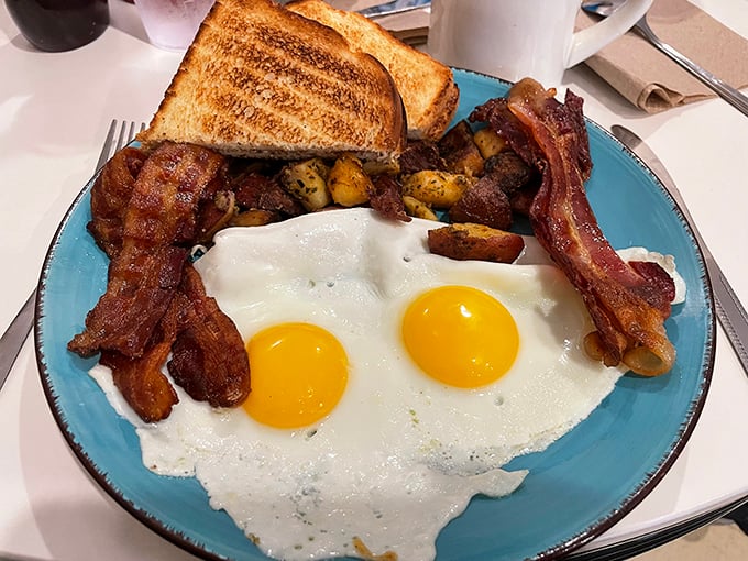 Two sunny-side up eggs stare back at you like old friends, while crispy bacon stands at attention. This isn't just breakfast—it's morning salvation.