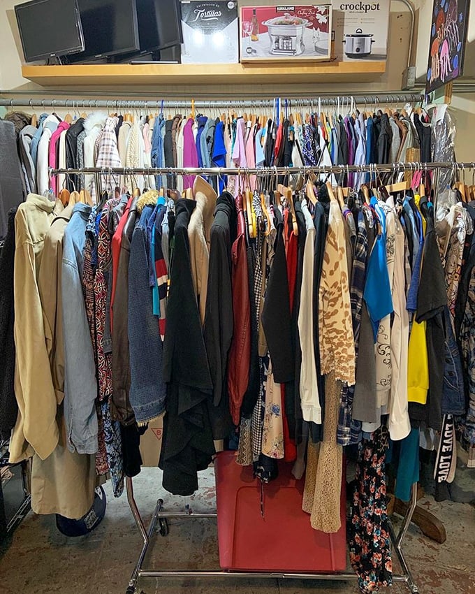 Fashion archaeology at its finest—racks of history where vintage patterns and modern styles coexist in a rainbow of second-chance possibilities.