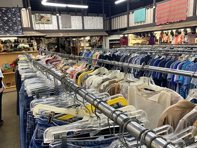 Clothing racks stretch toward the horizon, a textile rainbow organized by color rather than era – fashion democracy in its purest form.