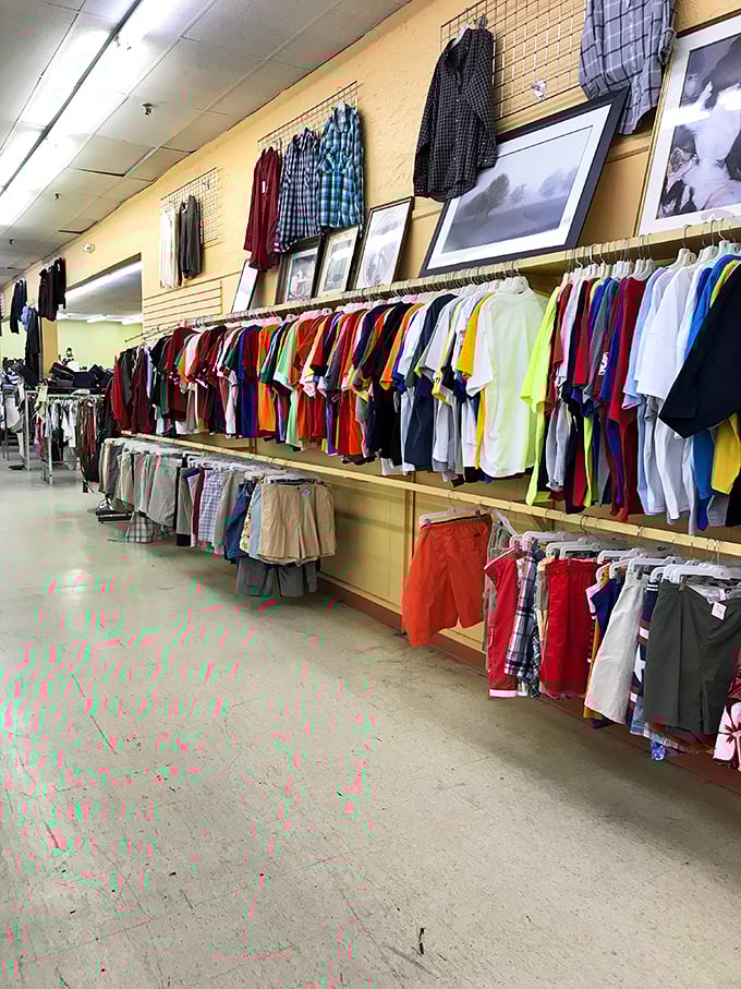 A rainbow of men's shirts arranged with military precision—proof that secondhand doesn't mean second-rate when it comes to building a wardrobe that works.