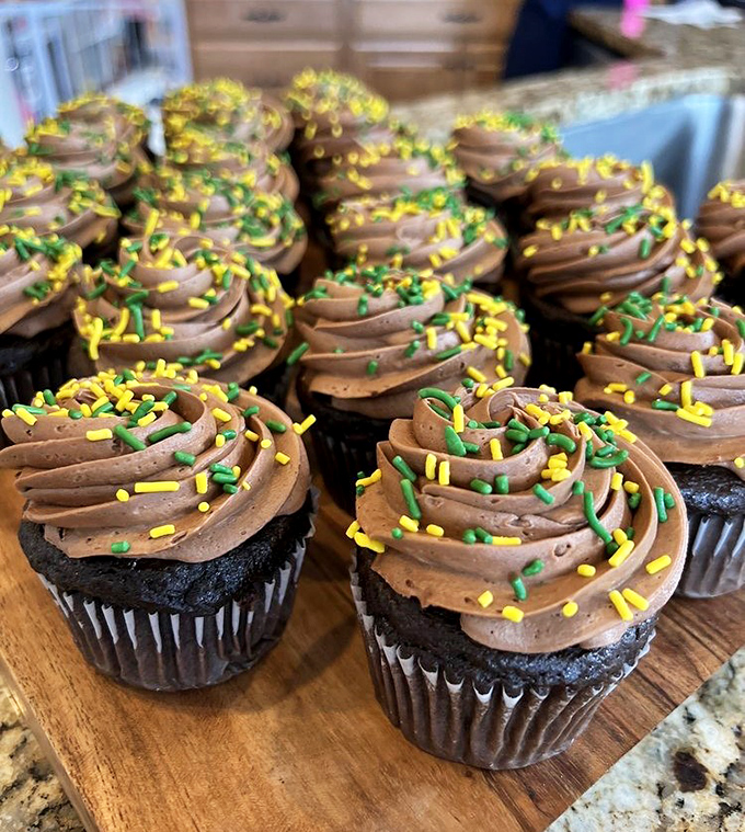 Chocolate cupcakes with perfectly piped frosting and festive sprinkles—architectural marvels of buttercream that somehow manage to look both elegant and playfully approachable.