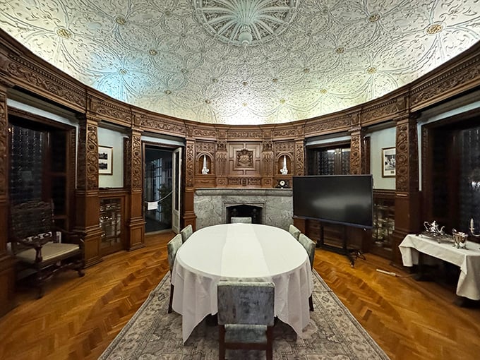 This circular dining room boasts a ceiling that would make Michelangelo do a double-take, with woodwork so intricate it deserves its own Instagram account.