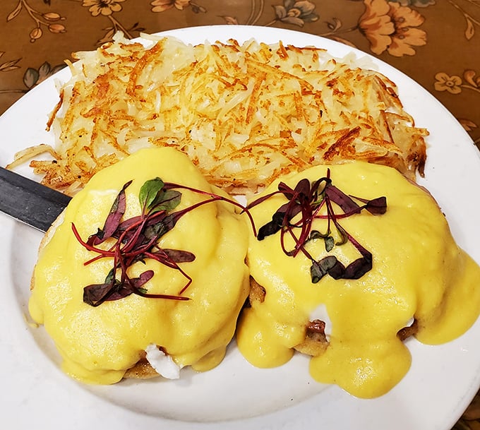 Eggs Benedict that would make a French chef weep with joy—golden hollandaise cascading over English muffins like a breakfast waterfall.