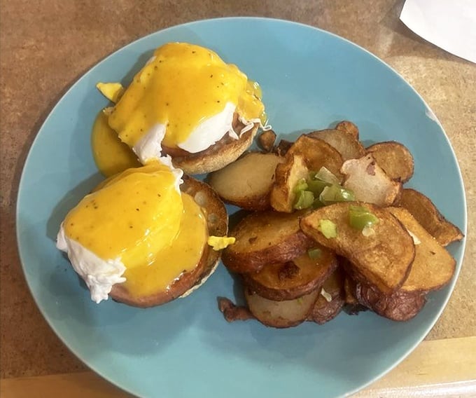 Behold: the Eggs Benedict that justifies the journey. That hollandaise sauce isn't just yellow—it's liquid sunshine on a plate.