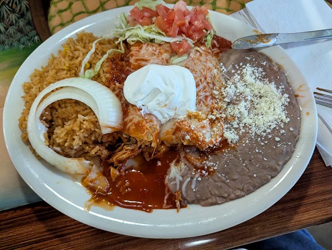 A plate that doesn't know the meaning of empty space. Rice, beans, shrimp, and that perfect white onion ring—a symphony of textures.