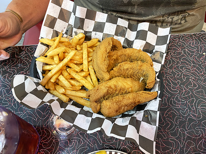 Golden-battered fish and perfectly crisp fries served on checkered paper—diner perfection that would make even coastal seafood snobs nod in reluctant approval.