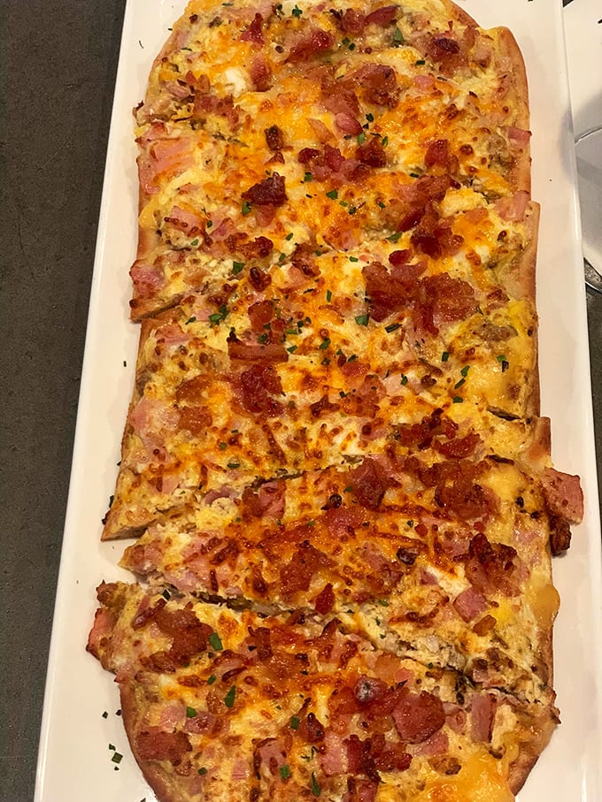 This isn't just flatbread; it's a masterclass in balance—crispy edges, melty cheese, and that perfect ratio of ham to bacon that makes you forget to take photos first.