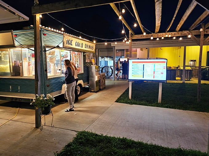 Ice Cold Drinks isn't just a sign—it's a promise of refreshment under string lights while intermission conversations flow as freely as the soda.