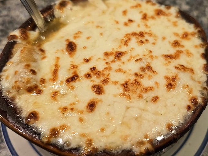 French onion soup that's achieved the perfect cheese-pull-to-broth ratio – a bubbling cauldron of comfort that's worth the inevitable chin dribble.