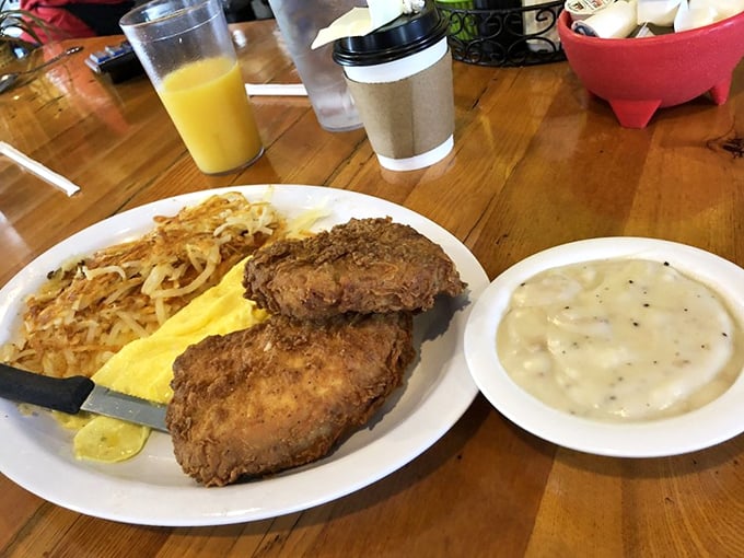 Crispy fried pork chops alongside golden eggs and hash browns – a plate that doesn't just say good morning, it shouts it with conviction.