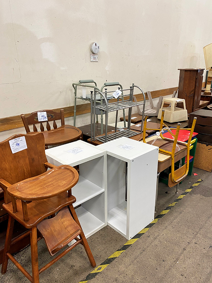 Wooden high chairs and shelving units stand like patient sentinels, waiting for their second chance. One person's discard, another's nursery centerpiece.