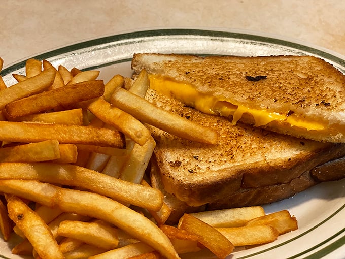 This isn't just a grilled cheese sandwich; it's childhood nostalgia served with a side of perfectly crisp fries and zero pretension.