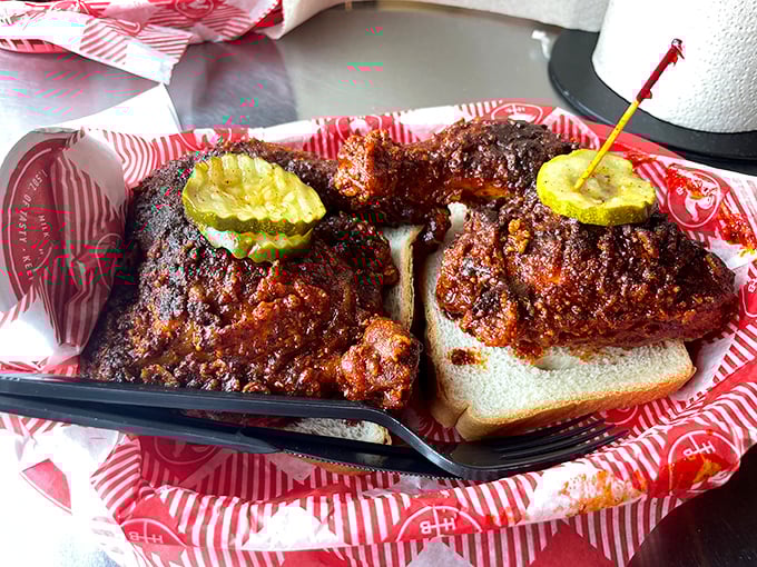 Dark, glistening, and unapologetically spicy—this chicken doesn't just satisfy hunger, it creates memories. Those pickle chips aren't garnish; they're essential fire extinguishers.