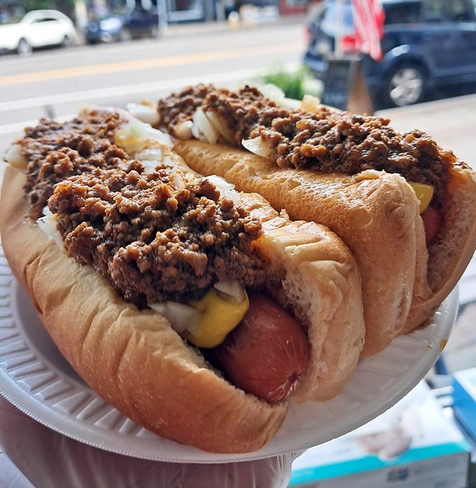These chili dogs aren't just topped—they're smothered with love. The kind of messy perfection that makes napkins essential and regrets impossible.