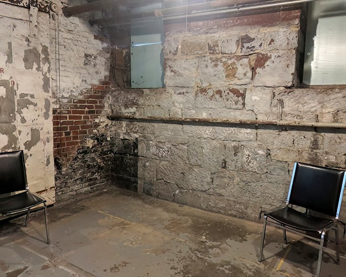 What stories these peeling walls could tell! The interrogation room's stark simplicity—just two chairs facing off—speaks volumes about power dynamics in criminal justice history.