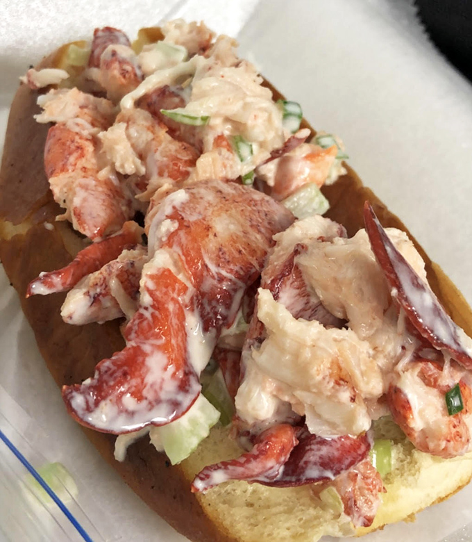 This isn't just a lobster roll—it's a love letter from Maine that somehow found its way to Florida, chunks of sweet meat barely contained by its vessel.