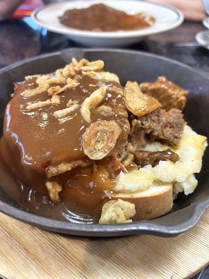 Behold the hot roast beef sandwich—where bread becomes a throne for tender meat, crowned with gravy that's clearly been simmering since breakfast.