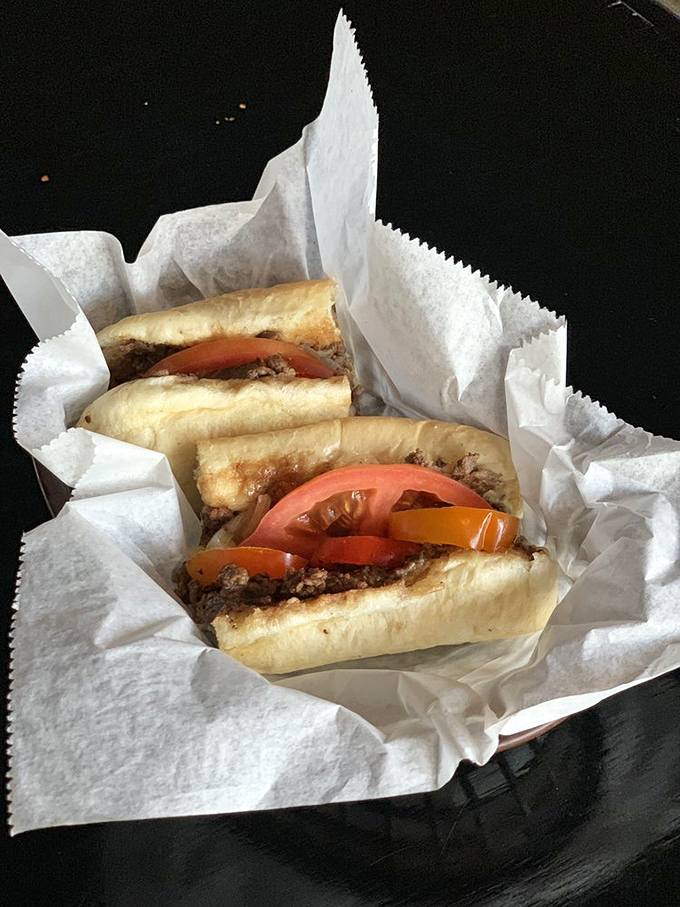 Behold the star of the show! Thinly sliced ribeye, perfectly melted cheese, fresh tomatoes, and peppers on a roll that would make Philly proud.