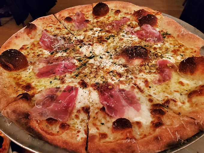 This prosciutto-topped masterpiece proves that sometimes the best things in life are circular, cheesy, and slightly charred around the edges.