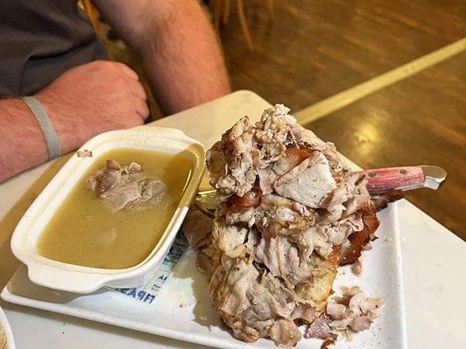 Porchetta so tender it practically surrenders to your fork, served with a savory jus that demands to be sopped up.
